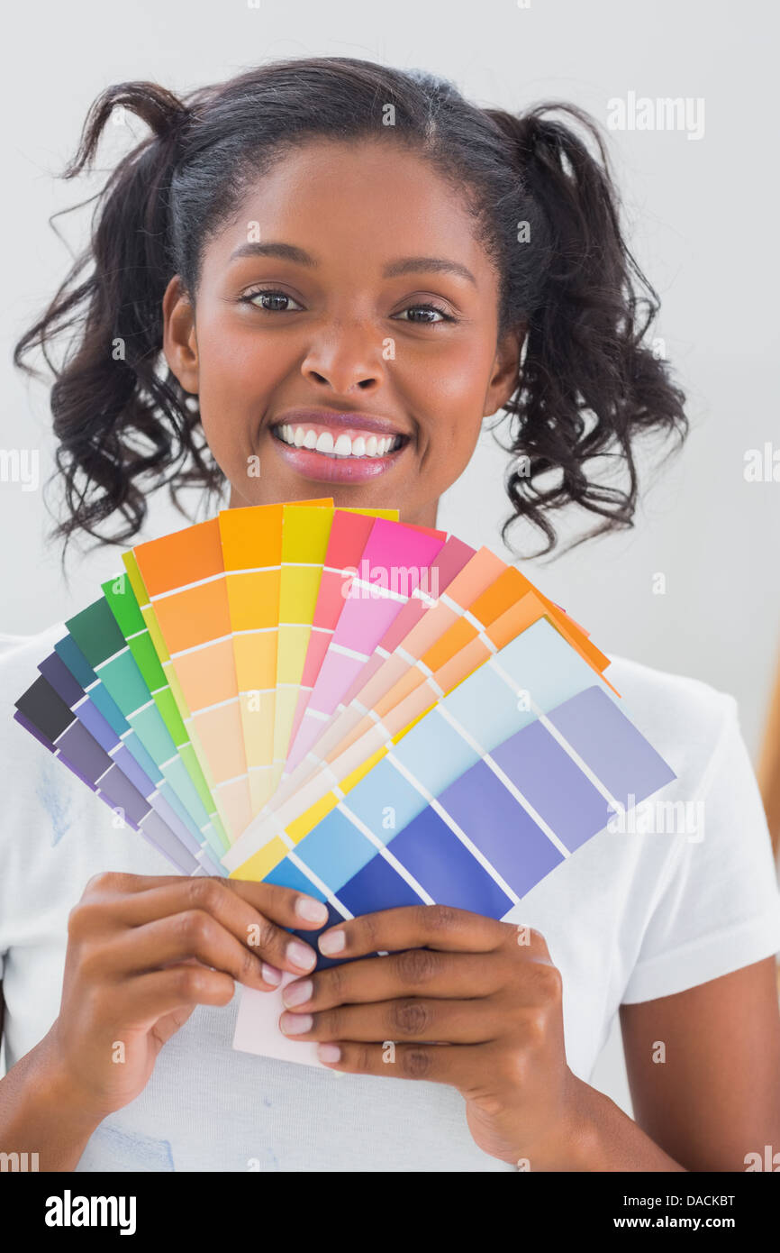 Smiling woman showing colour charts Stock Photo - Alamy