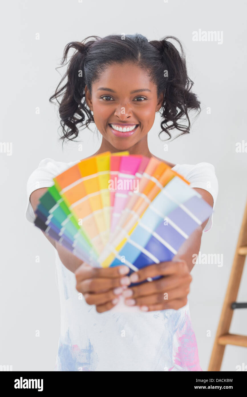 Excited woman showing colour charts Stock Photo - Alamy