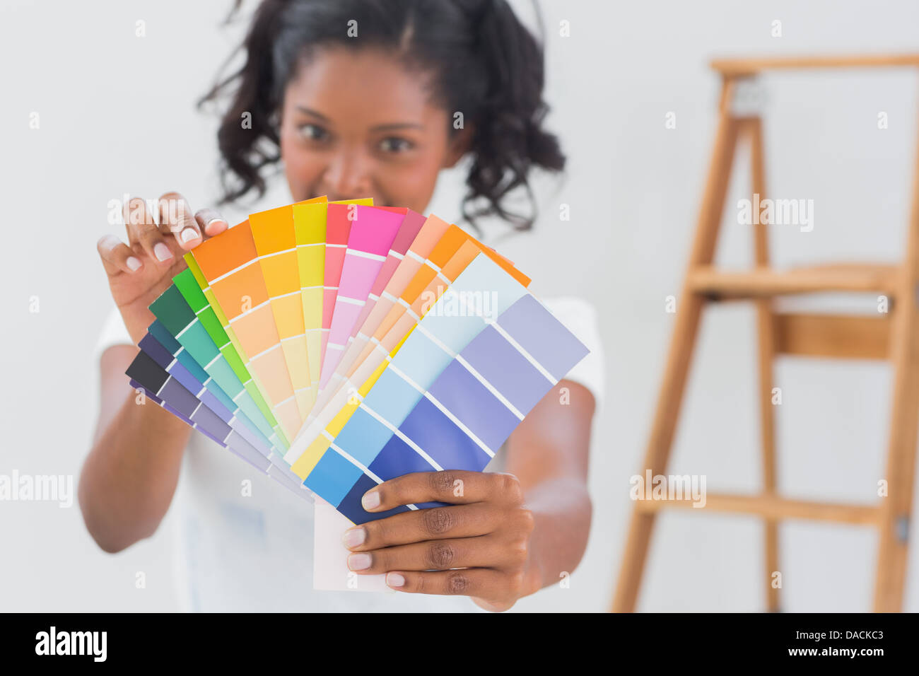 Excited woman showing colour charts Stock Photo - Alamy