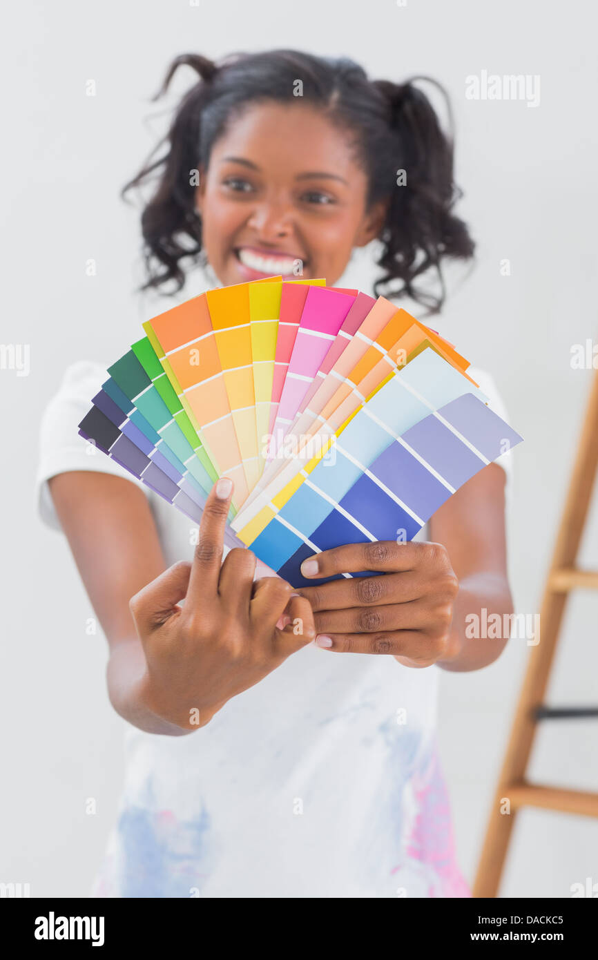 Excited woman showing colour charts and pointing Stock Photo - Alamy