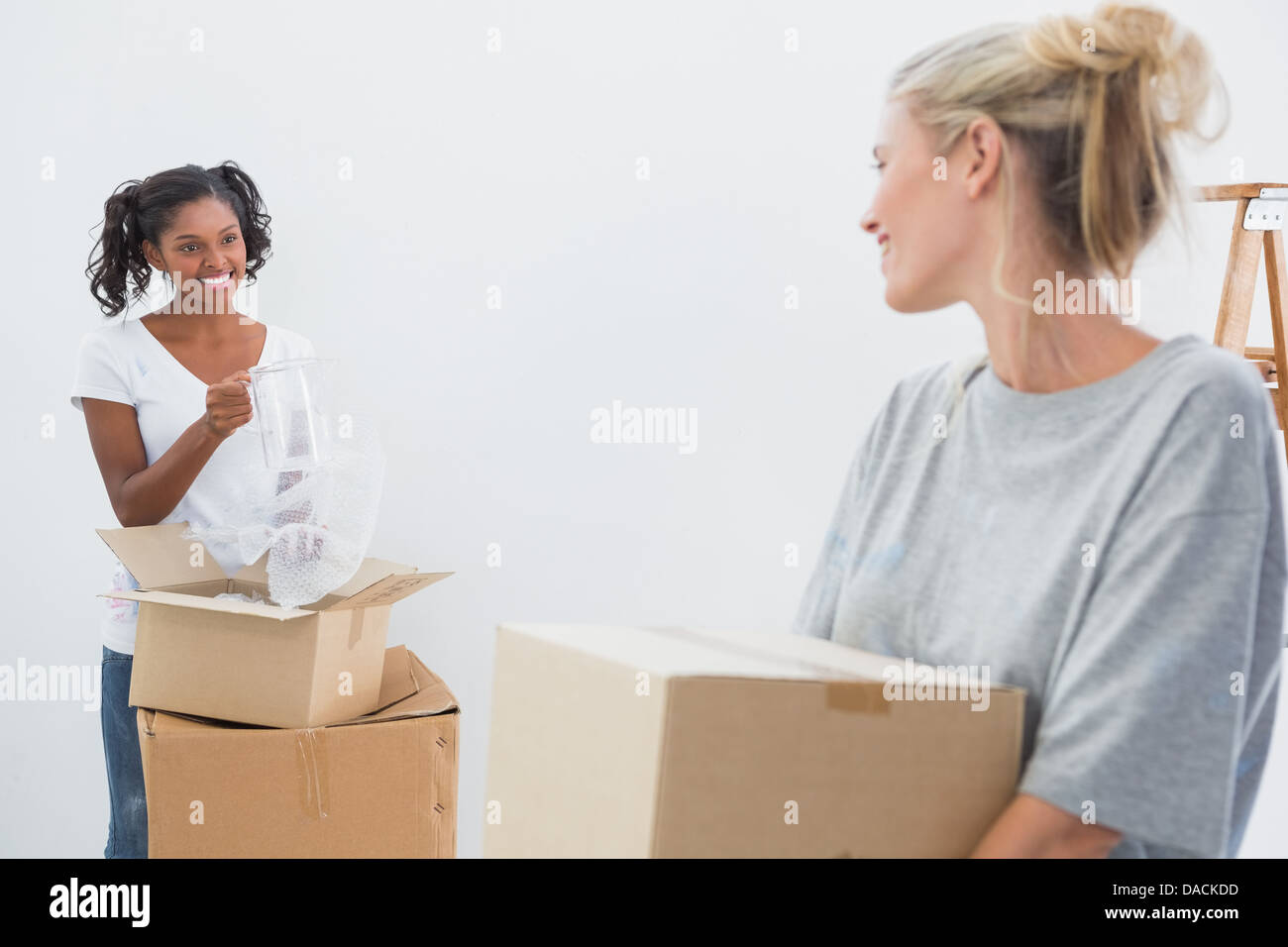 Cheerful young housemates moving into new home Stock Photo - Alamy