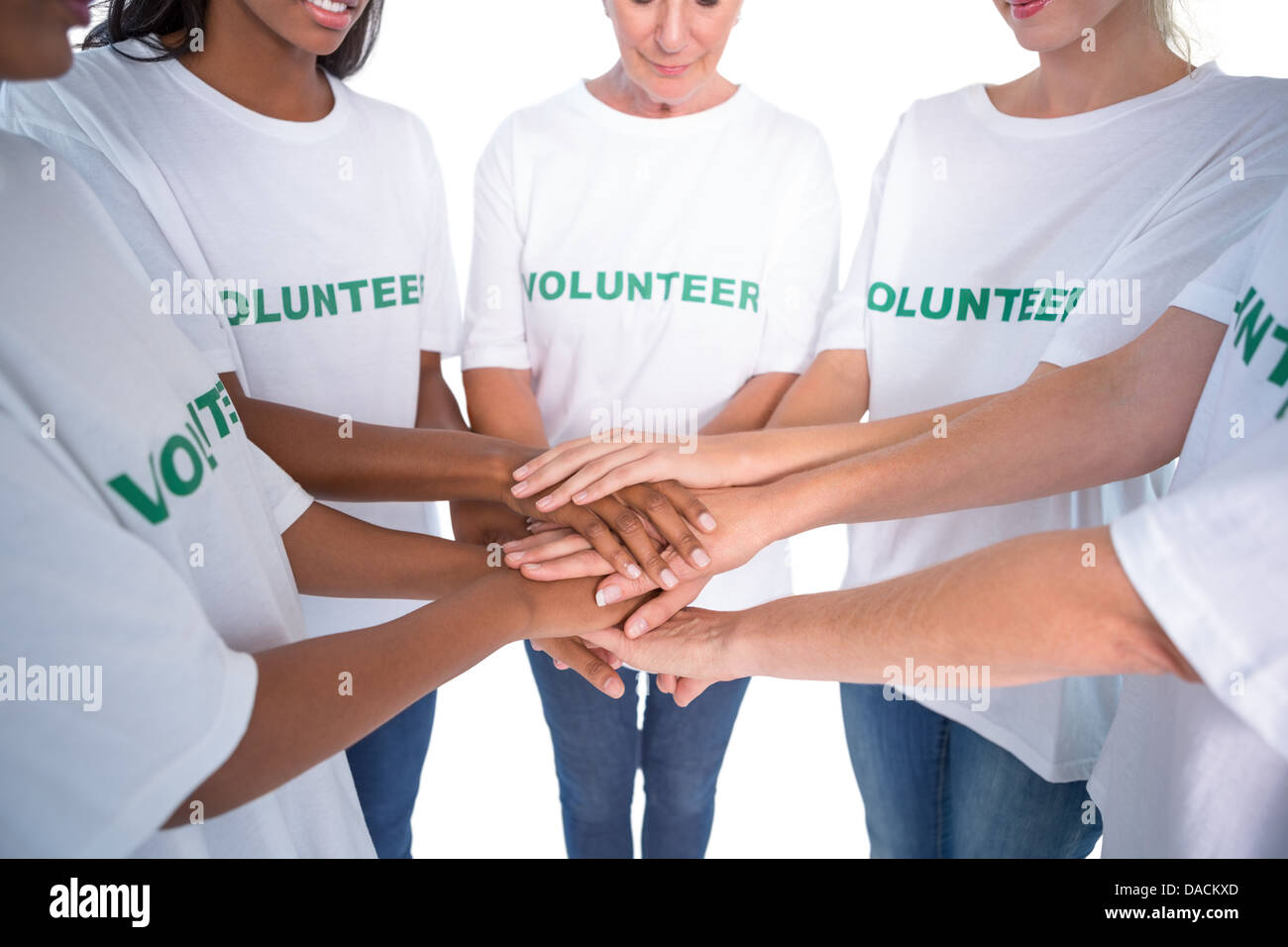 Group of female volunteers with hands together Stock Photo - Alamy