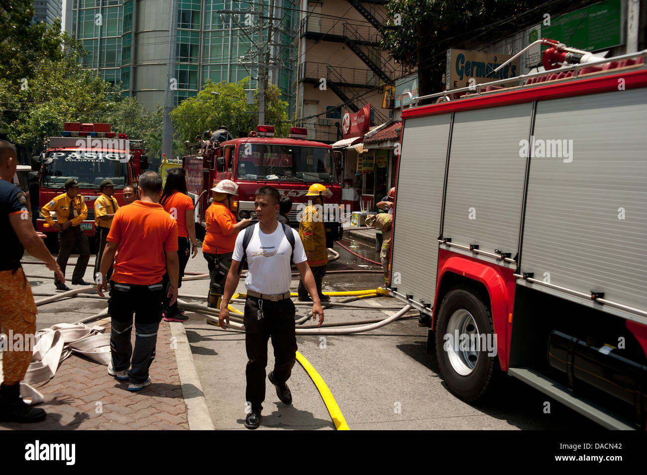 Firemen hose down a fire in a shanty town in Makati City, Metro Manila ...