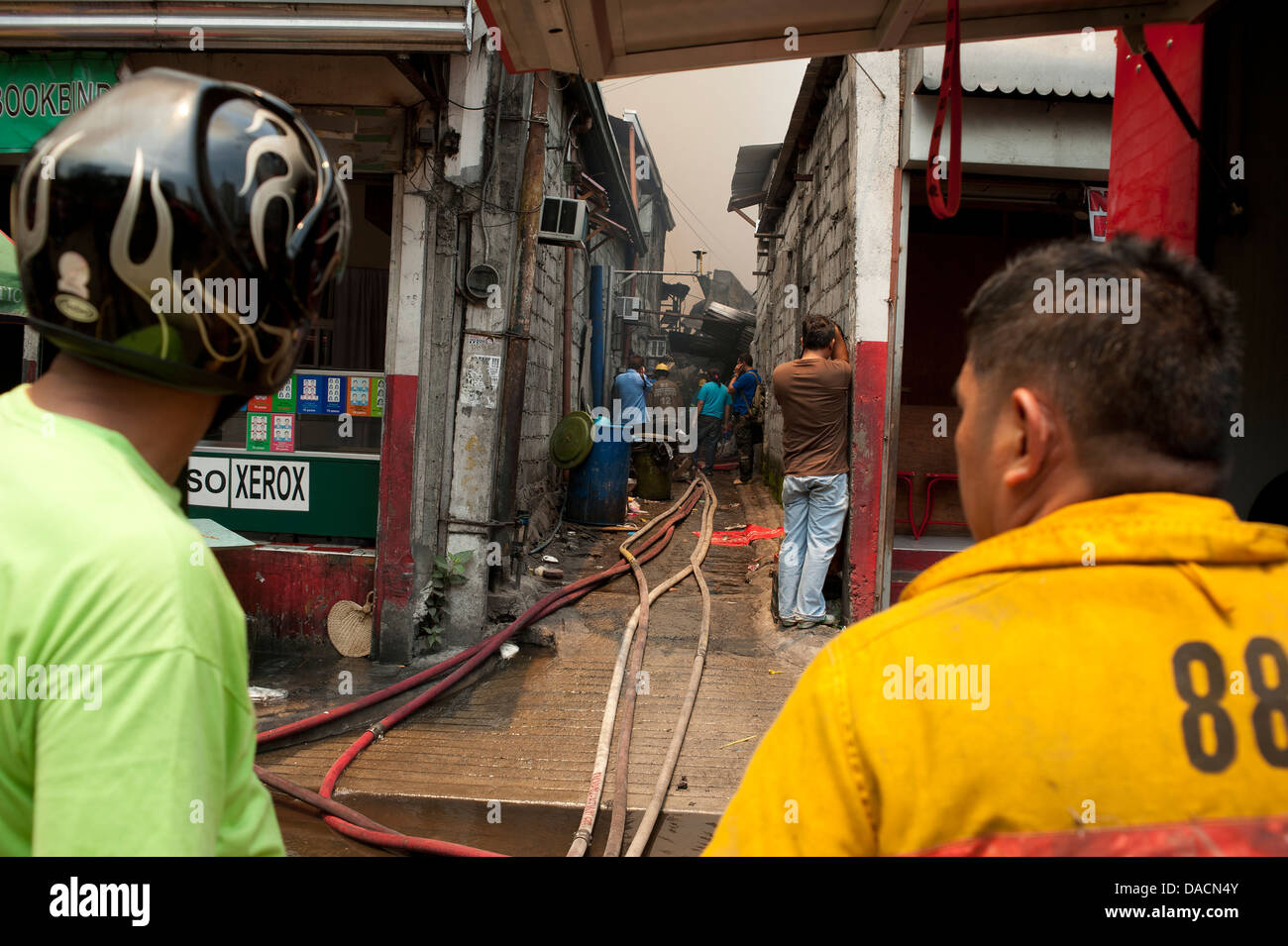 Firemen at a fire in a shanty town in Makati City, Metro Manila ...
