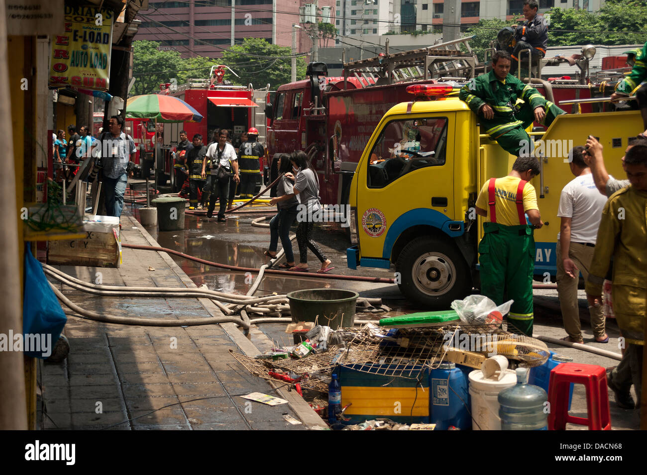 Firemen hose down a fire in a shanty town in Makati City, Metro Manila ...