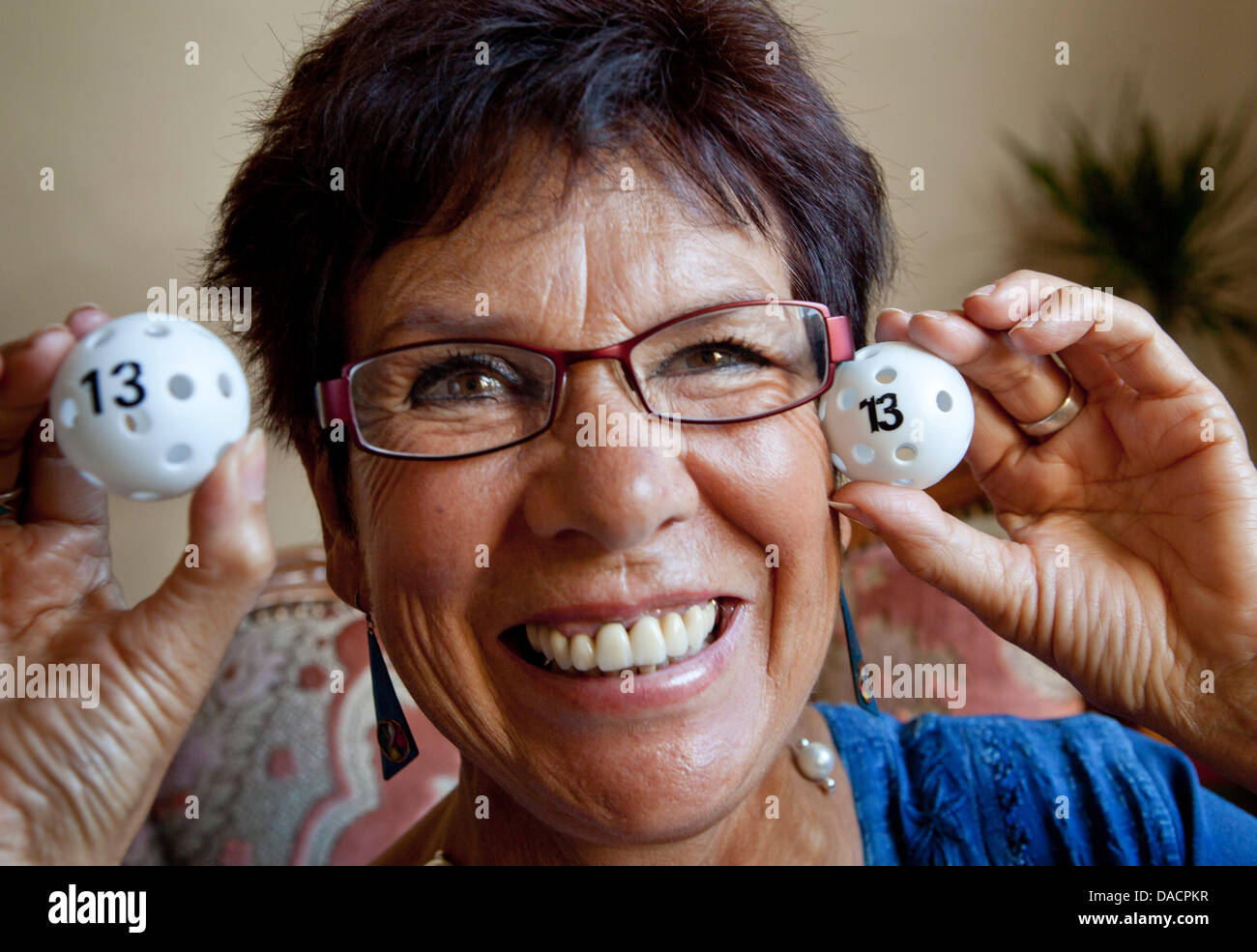 Germany's first lotto fairy, Elvira Hahn, holds two whit balls with the ...