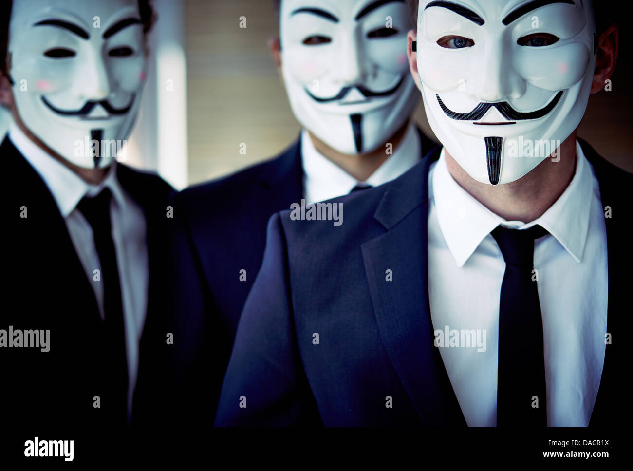 Close-up portrait of unrecognizable people wearing Guy Fawkes masks and ...
