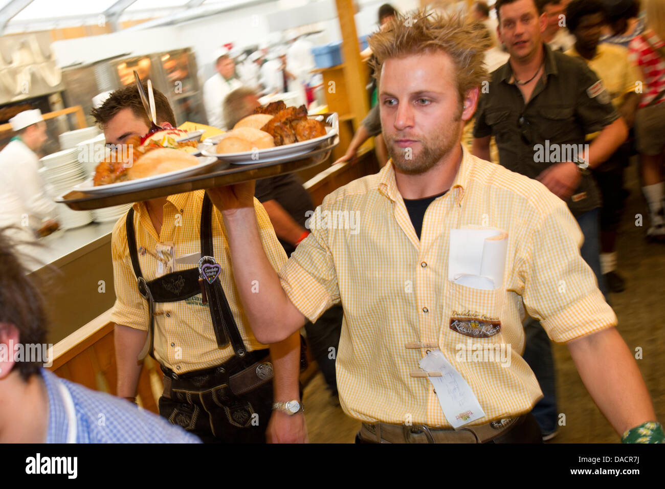 A host serves food in a party tent at the Canstatt Wasen in Stuttgart ...