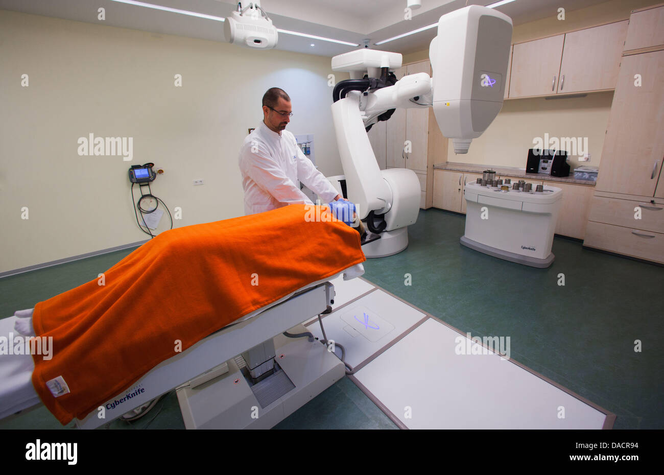 Radiotherapist Stefan Wurster puts a mask to a woman's face prior to ...
