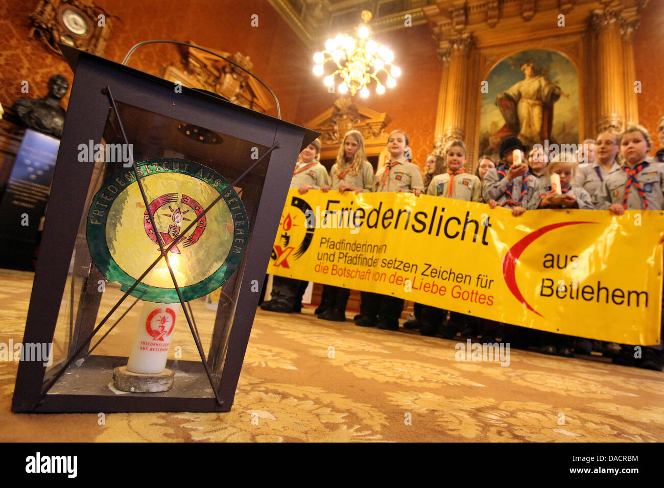 A candle ignited by the Bethlehem 'peace light' stands in front of a ...