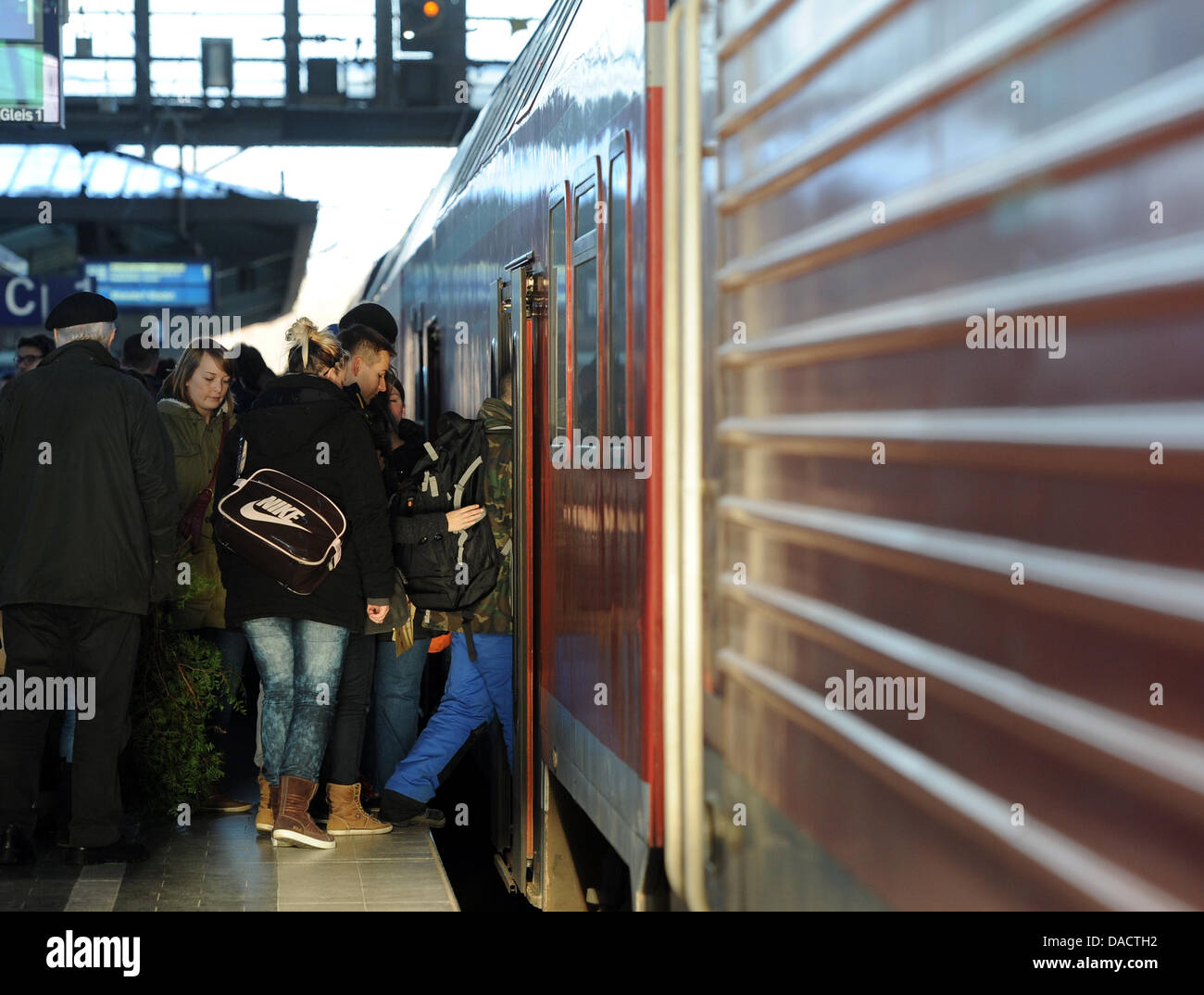 Passengers cram into a delayed regional train at the train station ...