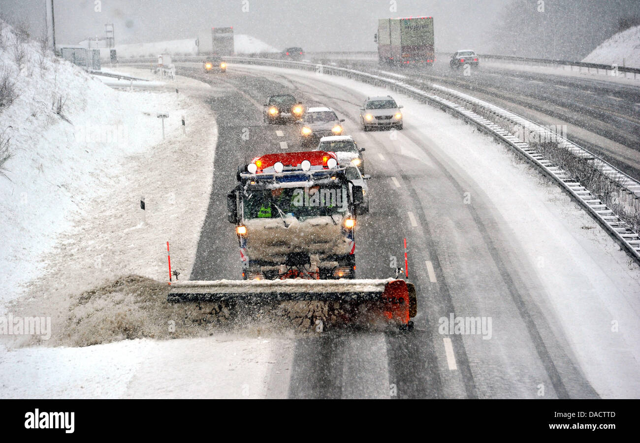 A winter service vehicle tries to clear the motorway A73 near ...