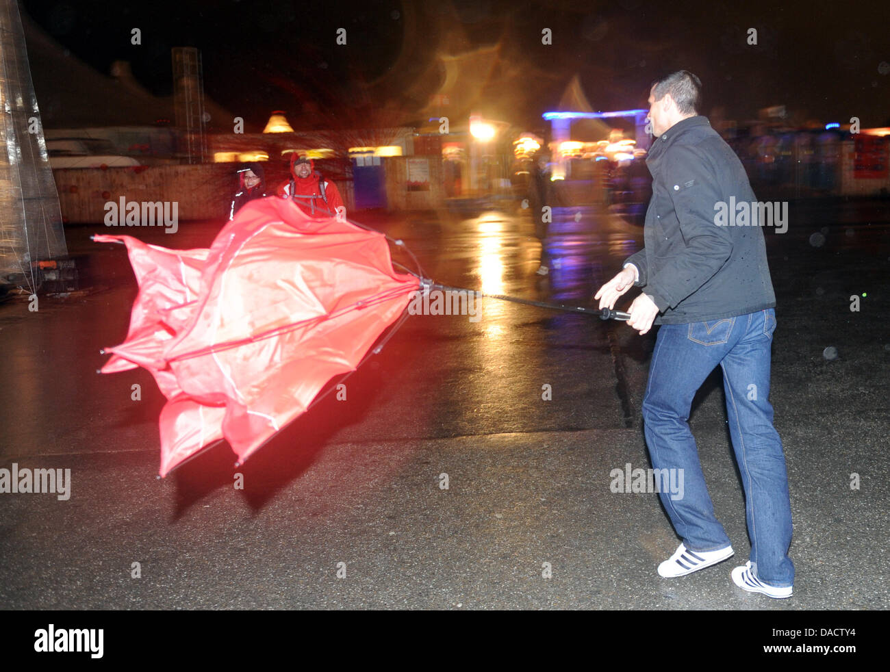 A man fight against the wind with an umbrella in Munich, Germany, 16 ...