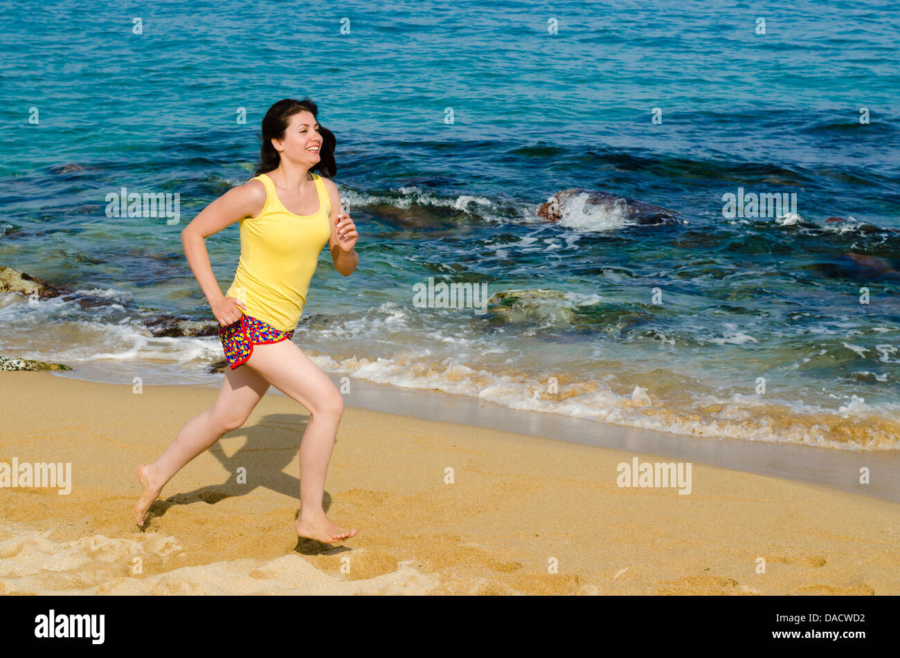 An active person running on a beach Stock Photo - Alamy