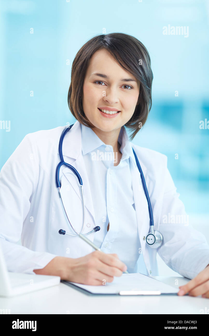 Vertical image of a friendly physician doing paperwork Stock Photo - Alamy