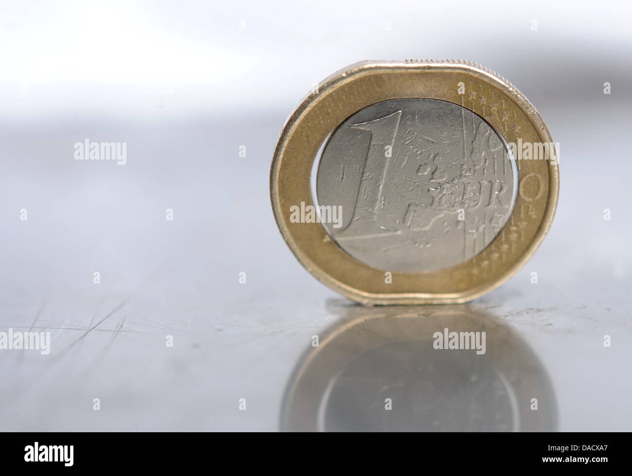 ILLUSTRATION - This illustration shows a damaged euro coin standing on ...