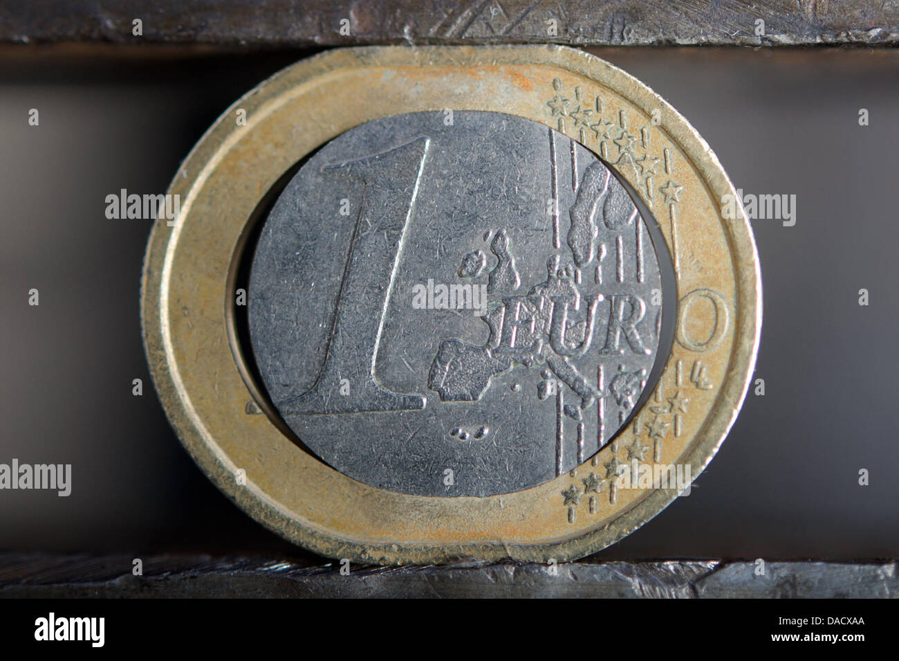 ILLUSTRATION - This illustration shows a damaged euro coin in a vise in ...