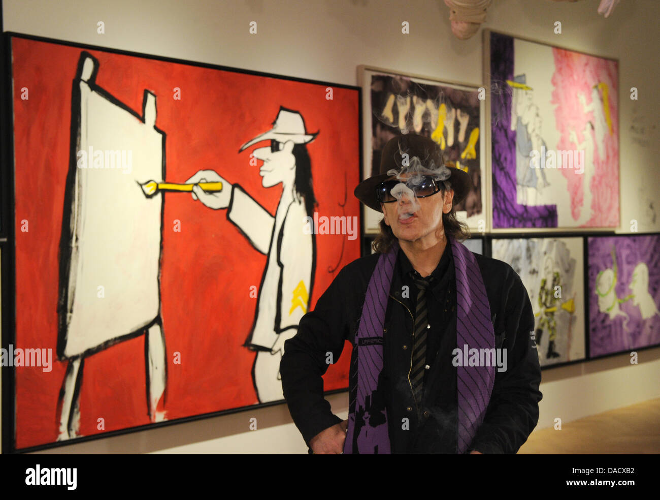Udo Lindenberg poses in front of some of his paintings during a tour of ...