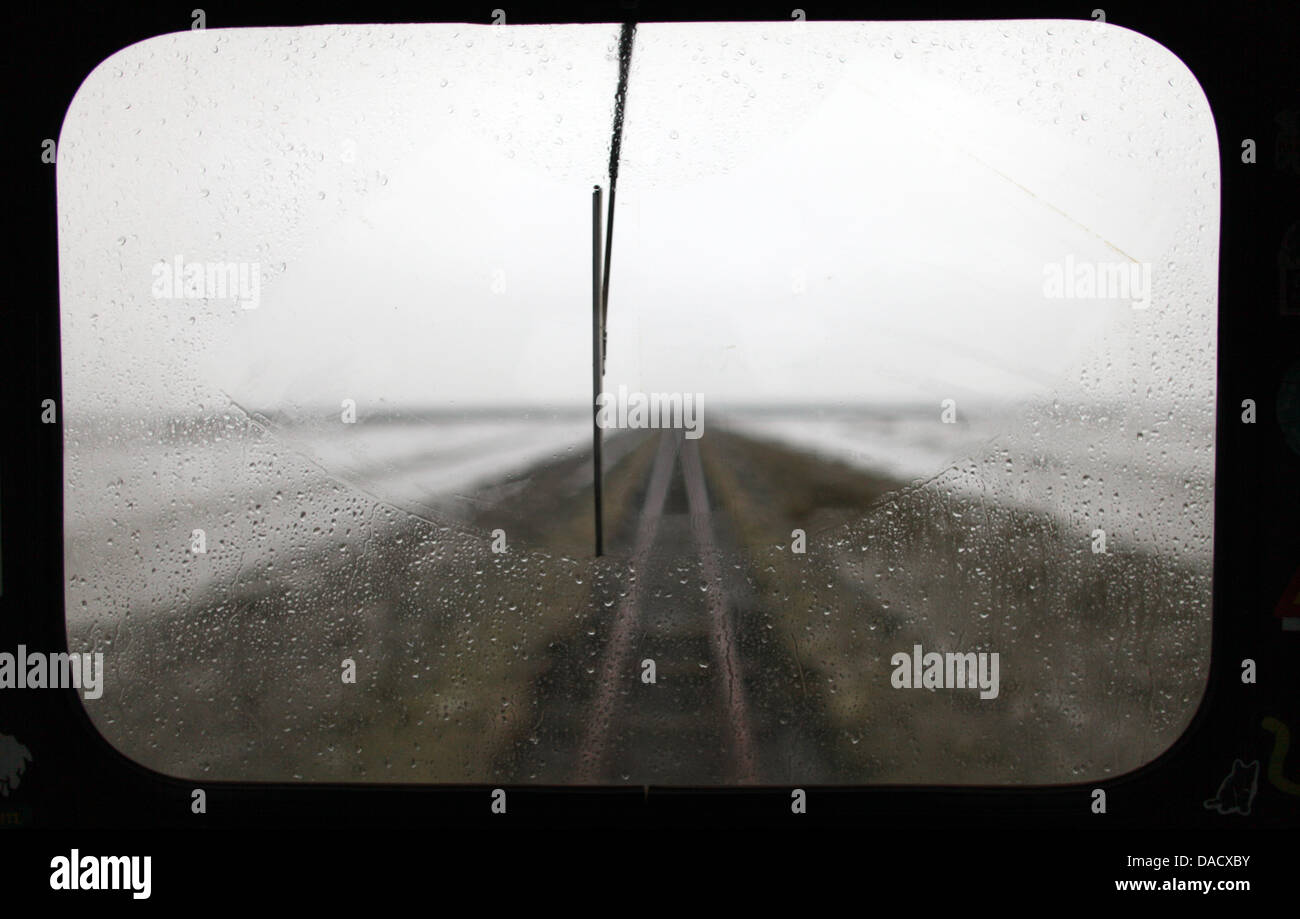 A windscreen wiper cleans the windshield of a train on the railway ...