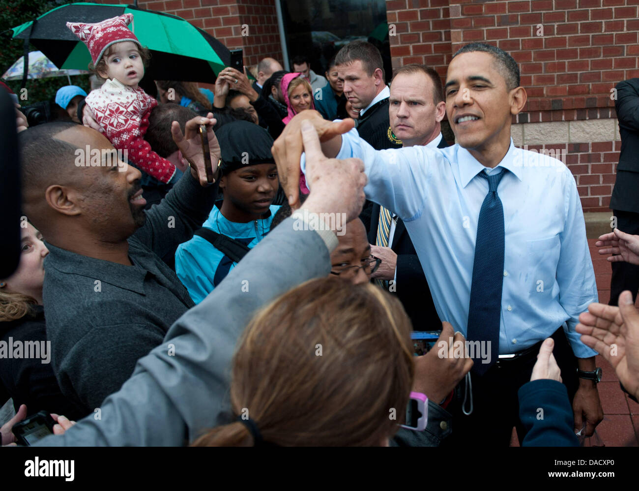 United States President Barack Obama greets people after shopping at a ...