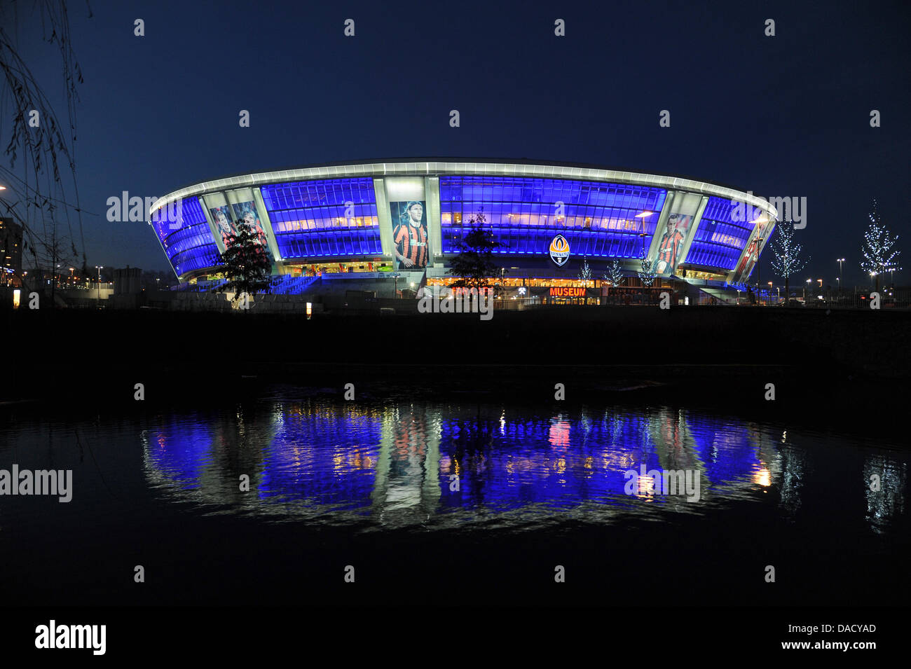 The Donbas Arena is illuminated and reflected in the water in Donezk ...