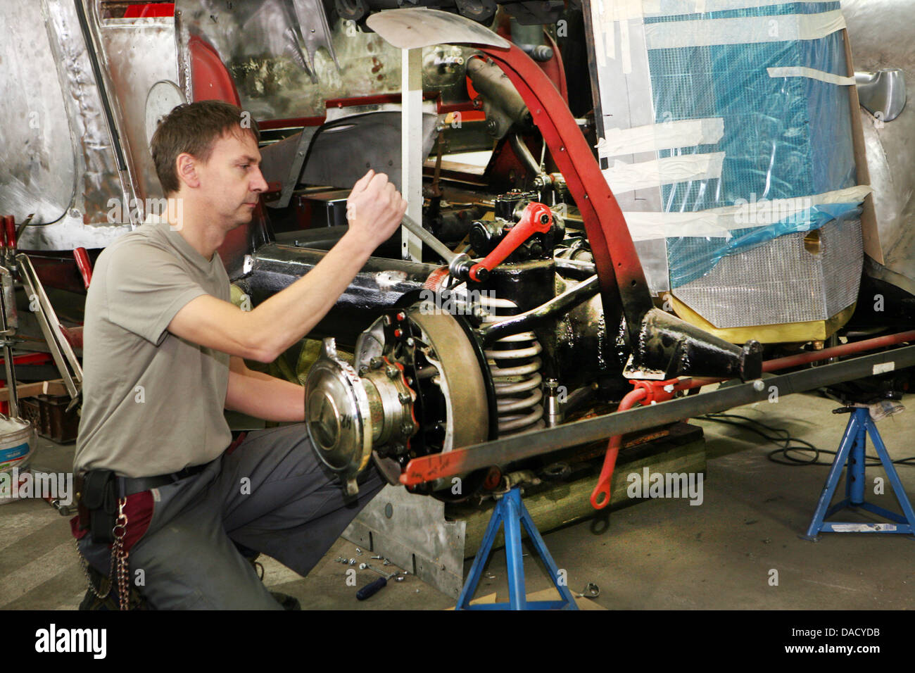 Automobile mechanic Peter Spillner works on the car body of a Mercedes ...