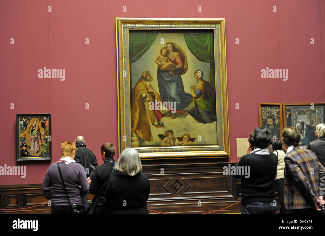 Visitors look at the Sistine Madonna by Raphael at the Gemaeldegalerie ...