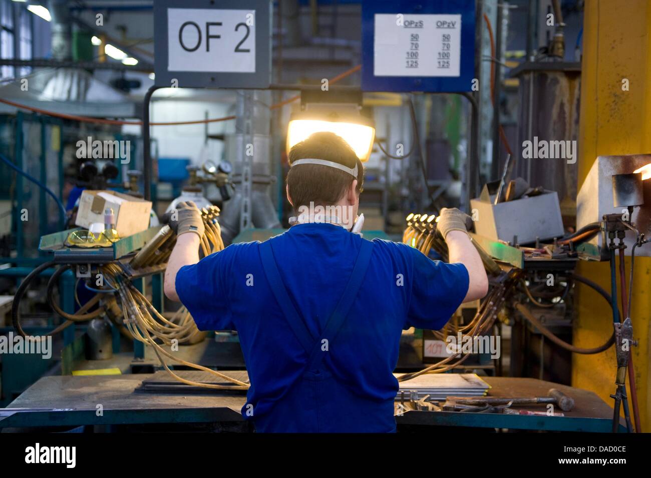 A battery craftsman solders batteries in a factory of the BAE battery ...