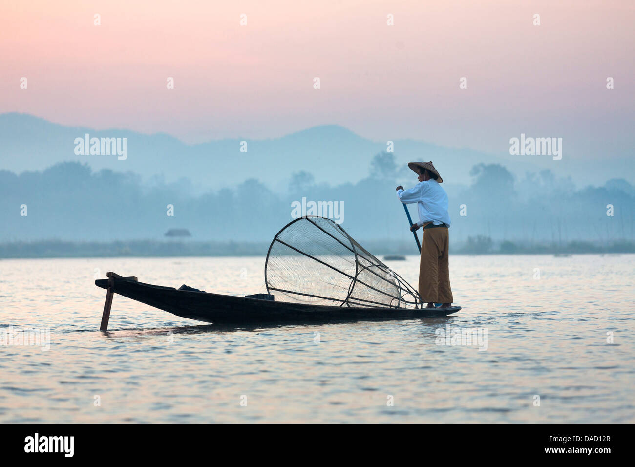Intha 'leg rowing' fishermen at sunset on Inle Lake, Inle Lake, Myanmar ...