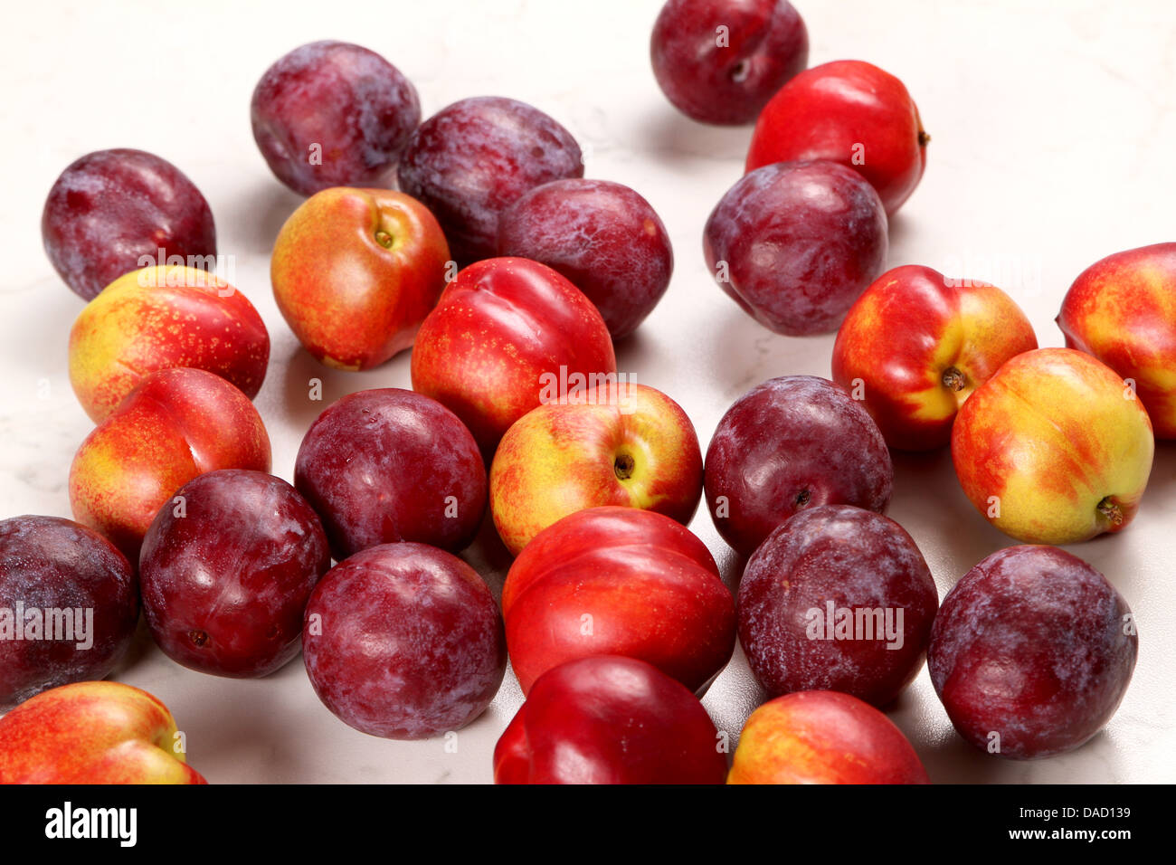 Nectarines and Plums on the kitchen table background Stock Photo - Alamy