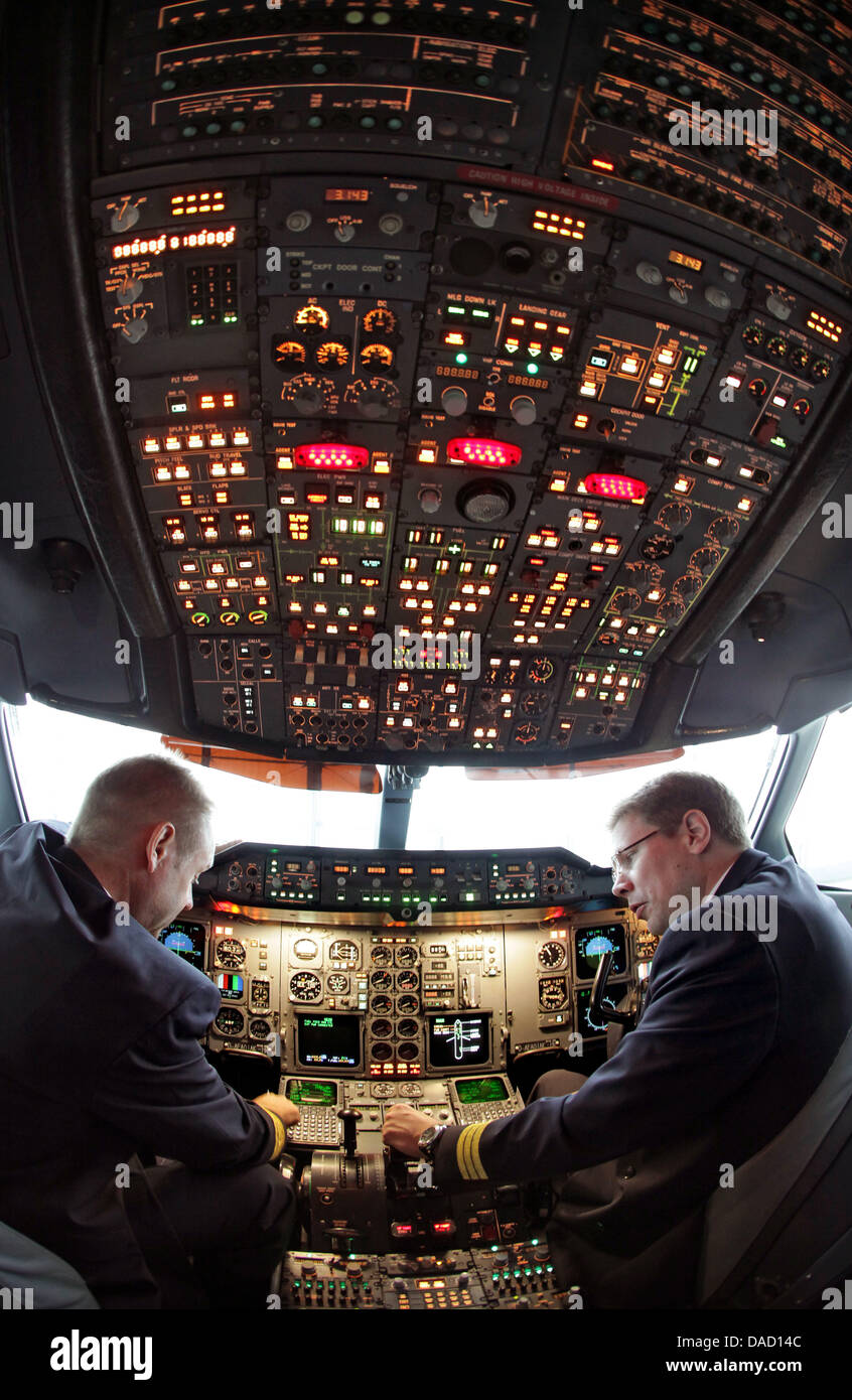 Two pilots are pictured in a cockpit of a reconstructed Airbus 300-600 ...