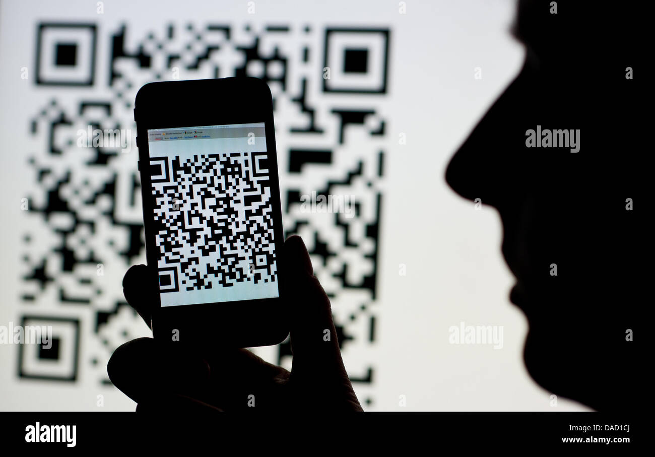 The illustration shows a woman holding a smartphone to a computer ...