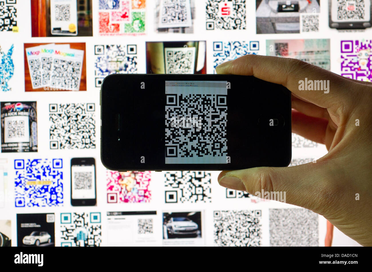 The illustration shows a woman holding a smartphone to a computer ...