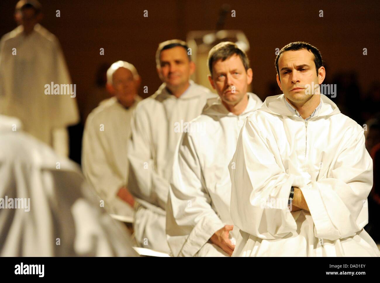 Taize monks attend a church service in a hall at the exhibition grounds ...
