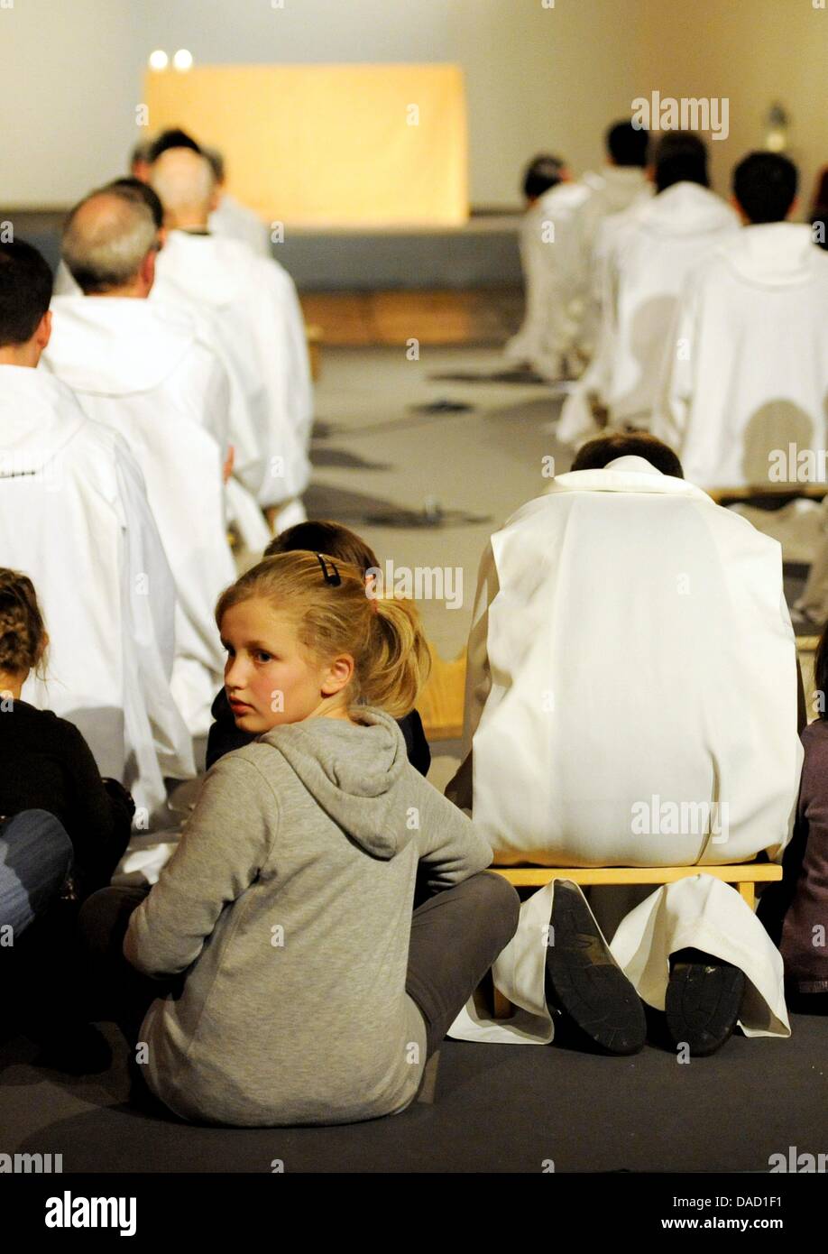 Young people and Taize monks attend a church service in a hall at the ...