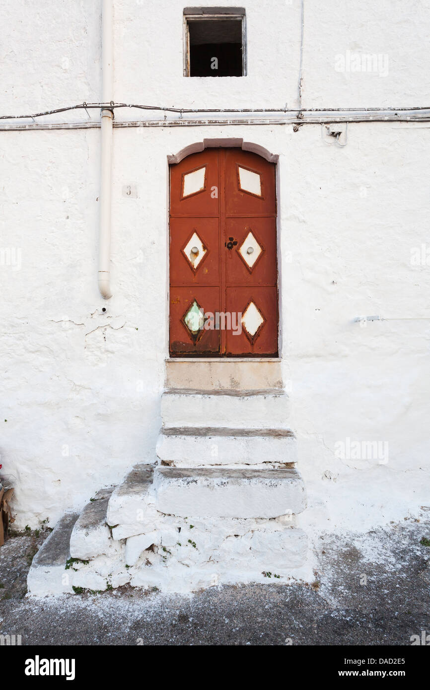 Red door with white diamond patterns in whitewashed wall, medieval ...