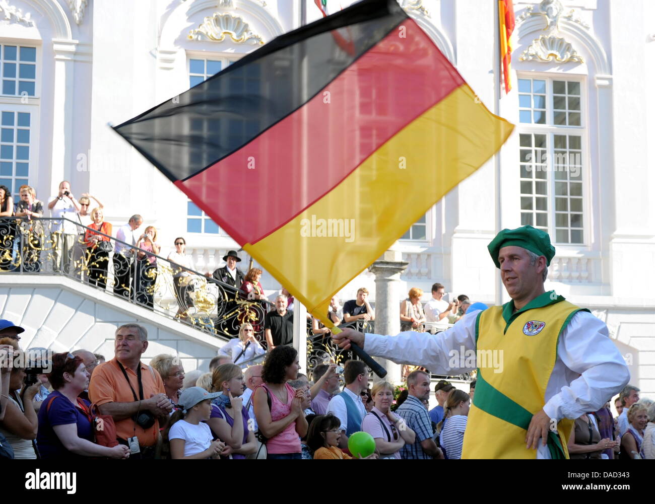 A man waves a flag at a parade on German Unity Day in Bonn, Germany, 03 ...