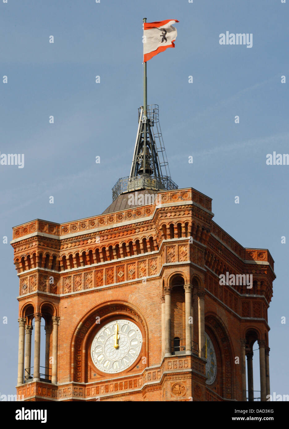 The Berlin flag flies in front of a blue sky atop the Red City Hall ...