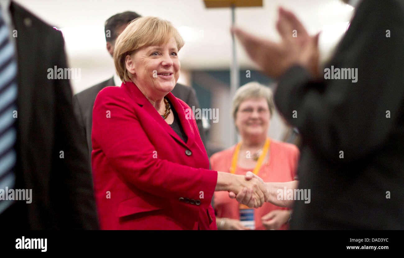 German Chancellor Angela Merkel (CDU) shakes hands as she arrives for ...