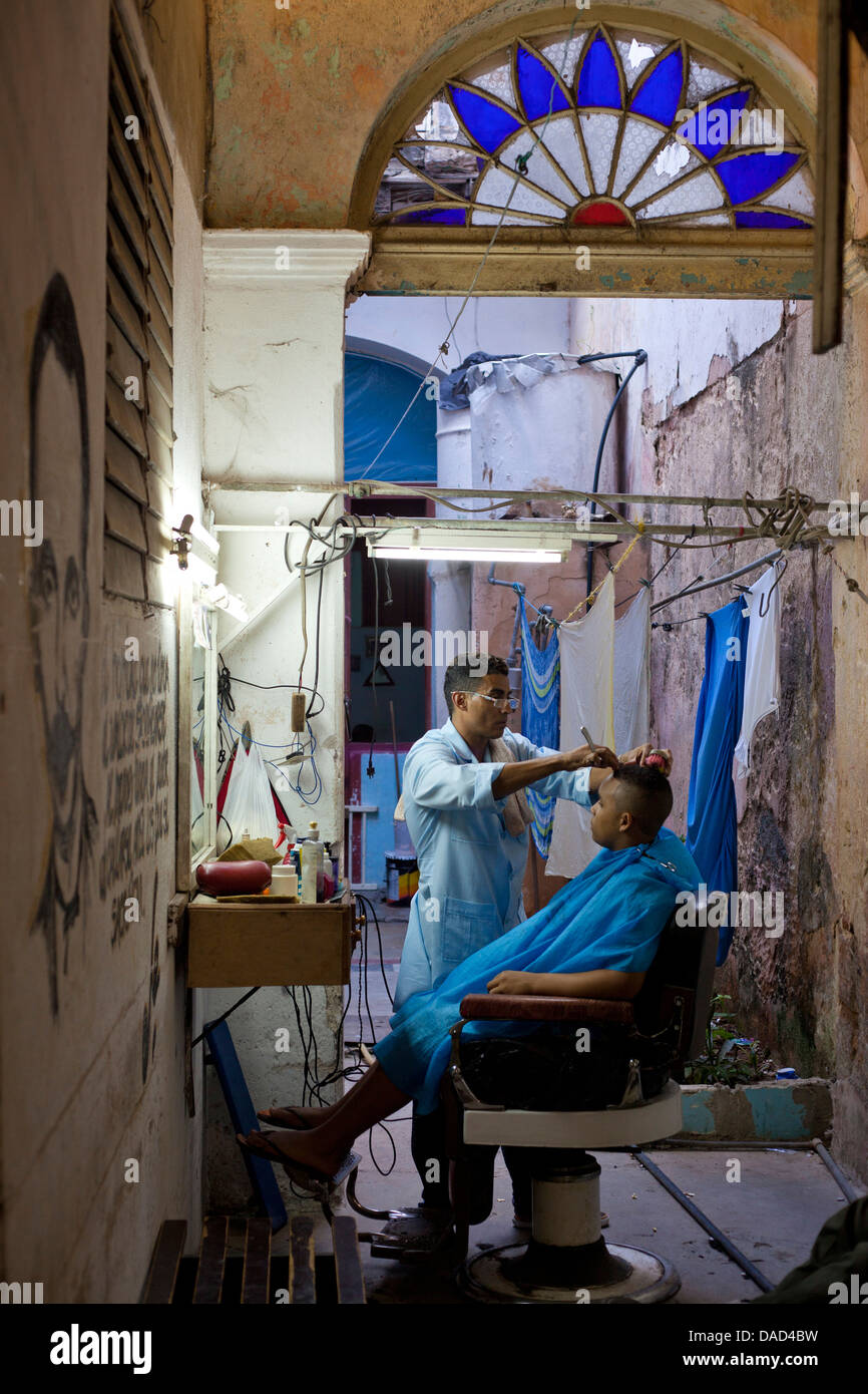 Man having haircut in backstreet barber shop, Havana Viejo, Havana ...