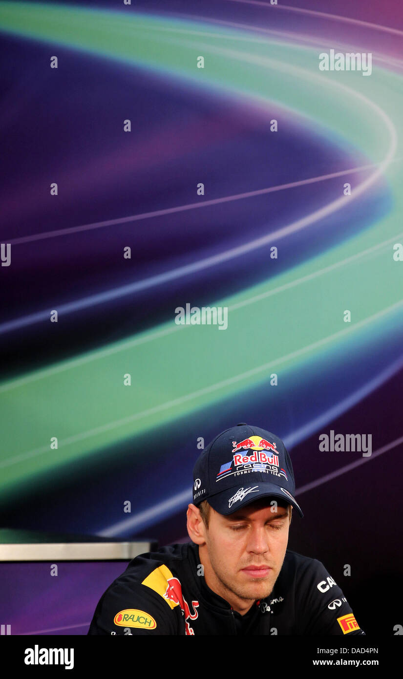 German Formula One driver Sebastian Vettel of Red Bull Racing listens ...