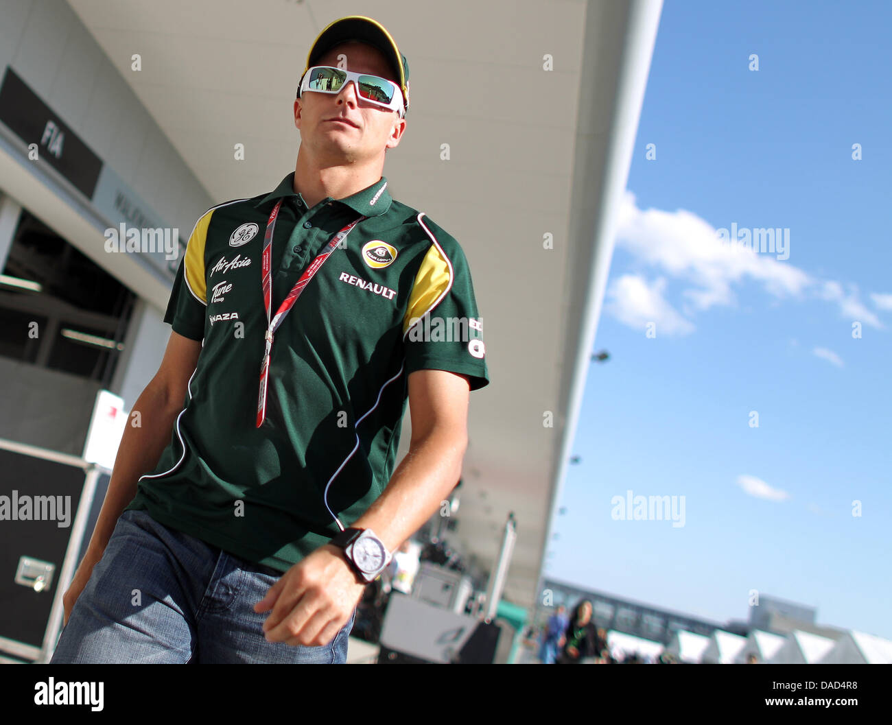 Finnish Formula One driver Heikki Kovalainen of Lotus walks through the ...