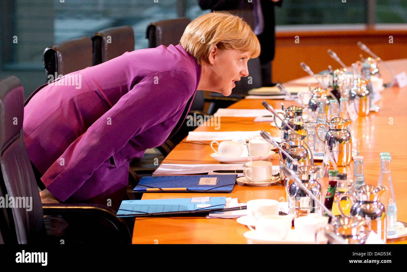 German Chancellor Angela Merkel prepares to sit before a second meeting ...