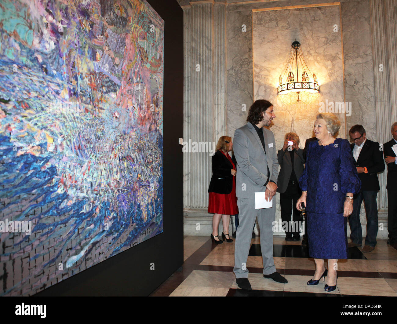 Dutch Queen Beatrix (R) talks to Omar Koubaa during the awarding of the ...