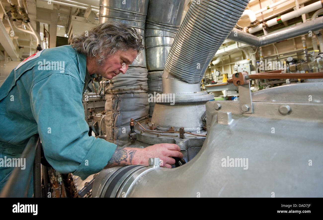 A crew member stands inside the engine room of the rescue vessel 'John ...