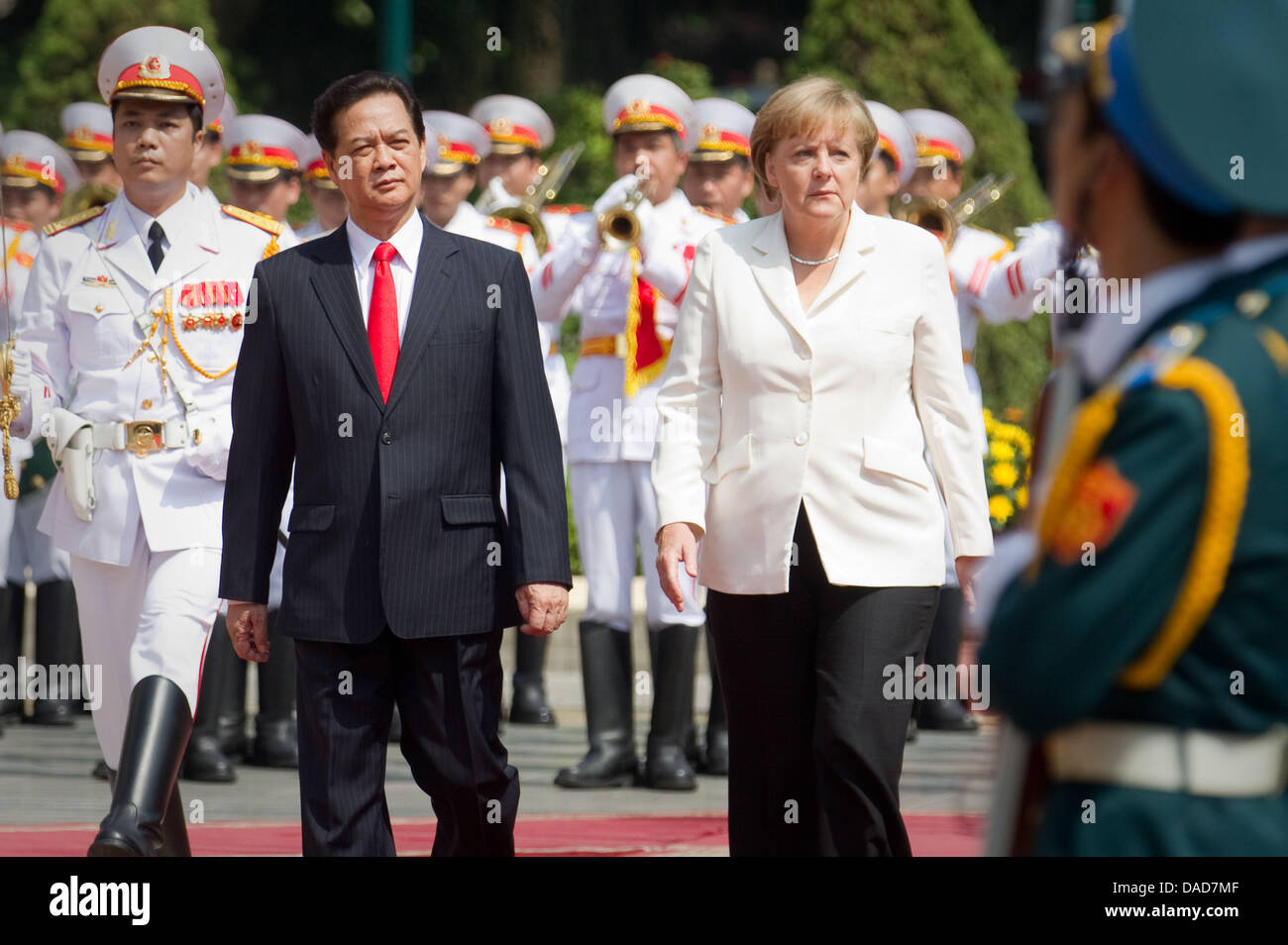 Chancellor Angela Merkel walks next to Prime Minister Nguyen Tan Dung ...