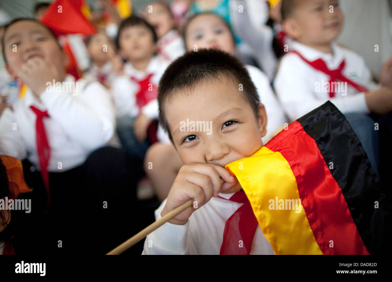 A Vietnamese boy holds a German flag Tourist guide while German ...