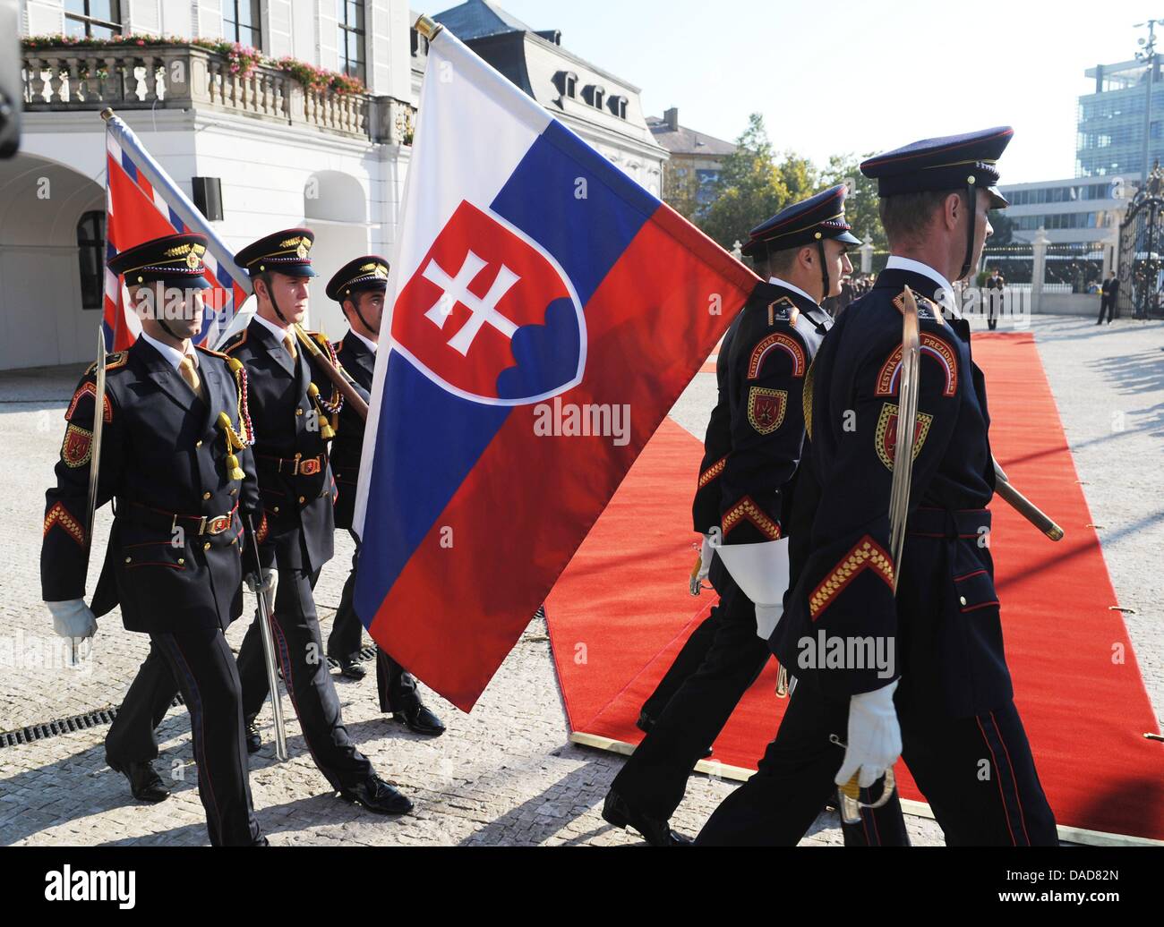 The honoury guard carries the Slovakian flag in front of the ...