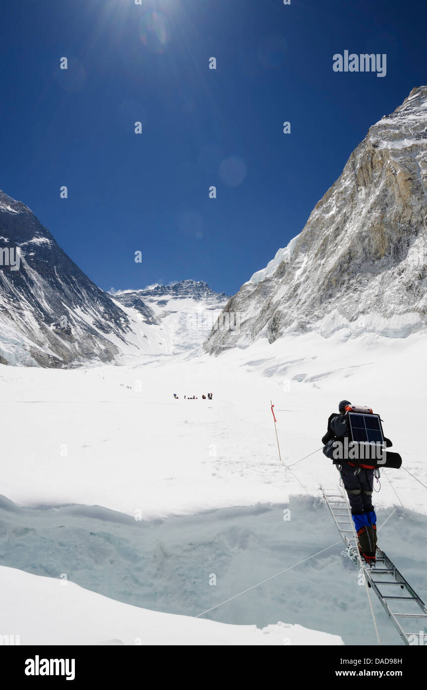 Climbers crossing crevasse and ladder on Mount Everest, Solu Khumbu ...