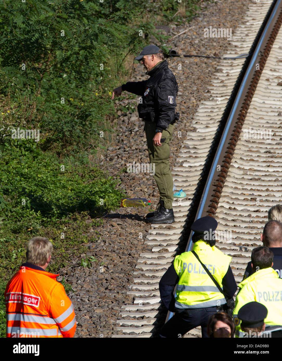Police officers confiscate an incendiary device near the train station ...
